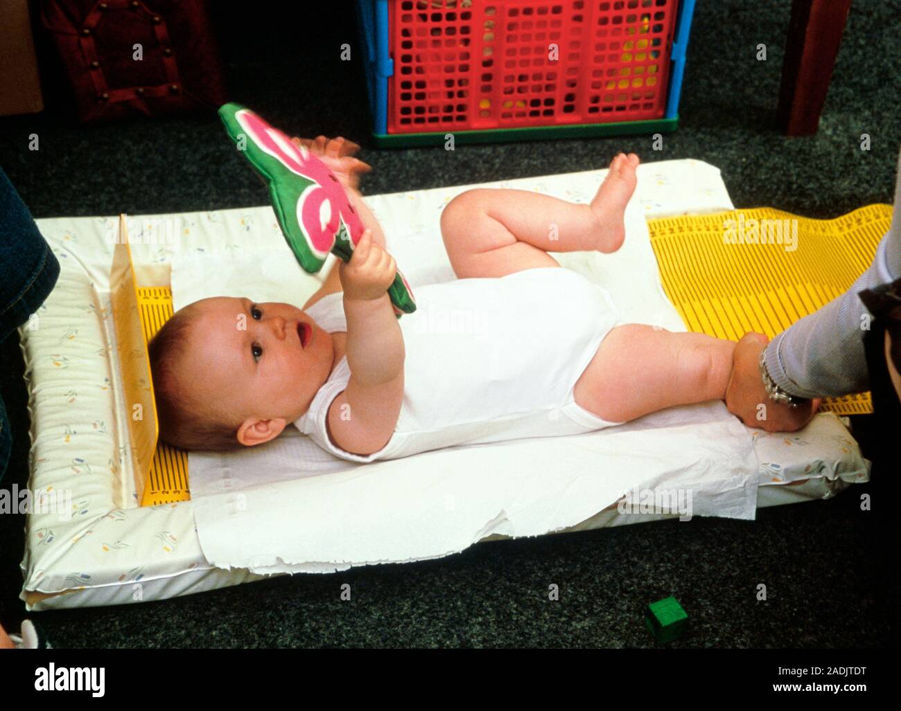 Baby length measurement. Health worker measuring the length of a baby ...