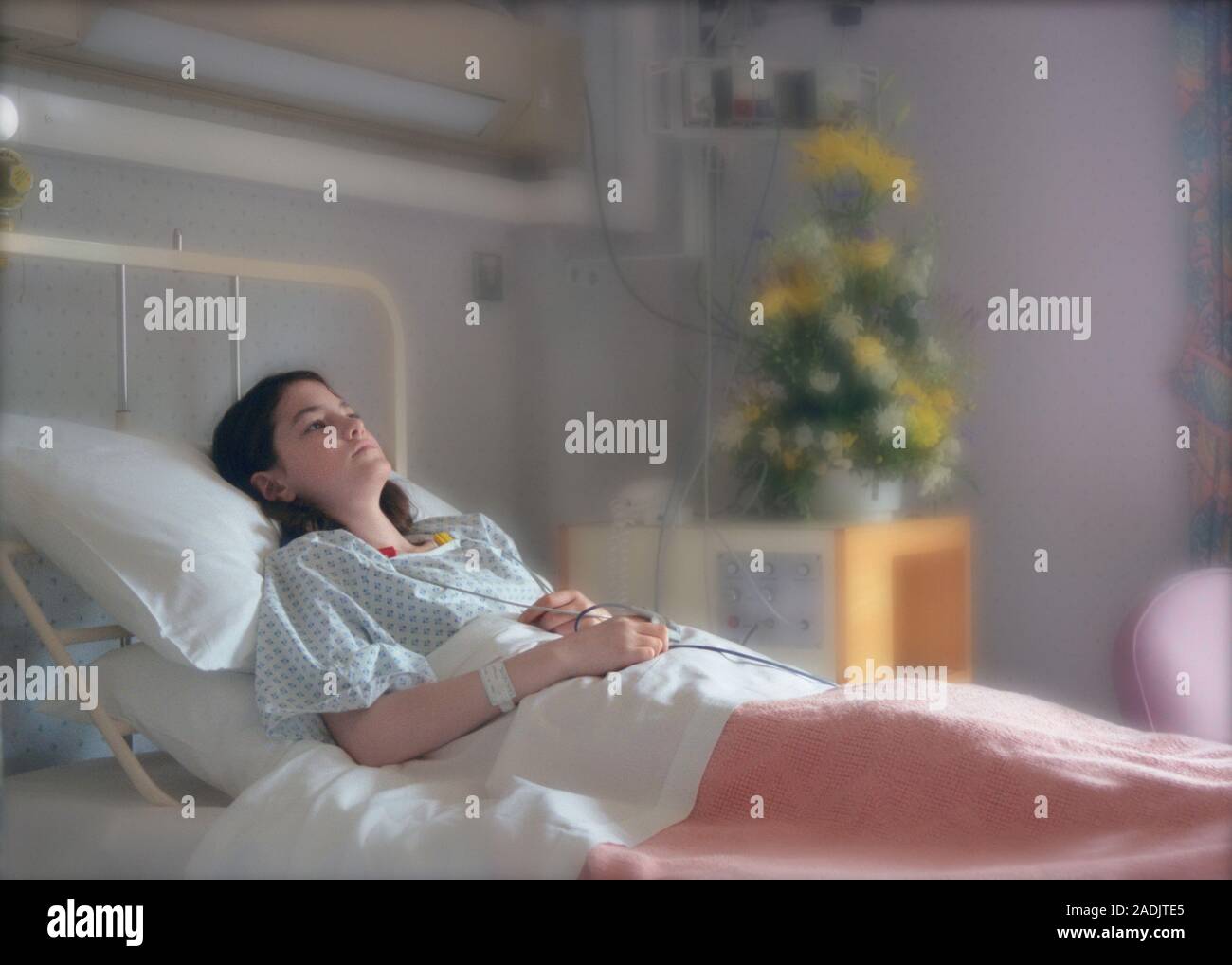 Sad girl in a hospital bed Stock Photo - Alamy