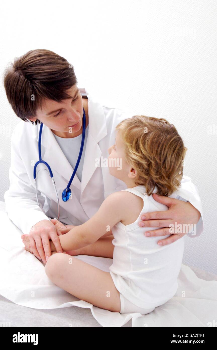 MODEL RELEASED. Paediatric examination. Doctor talking with a child ...