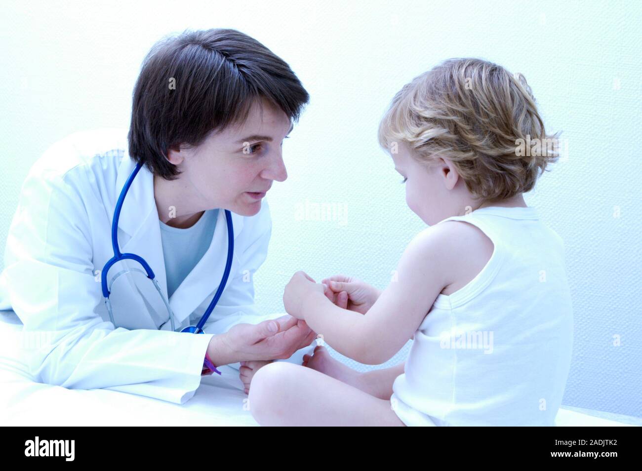 MODEL RELEASED. Paediatric examination. Doctor talking with a child ...