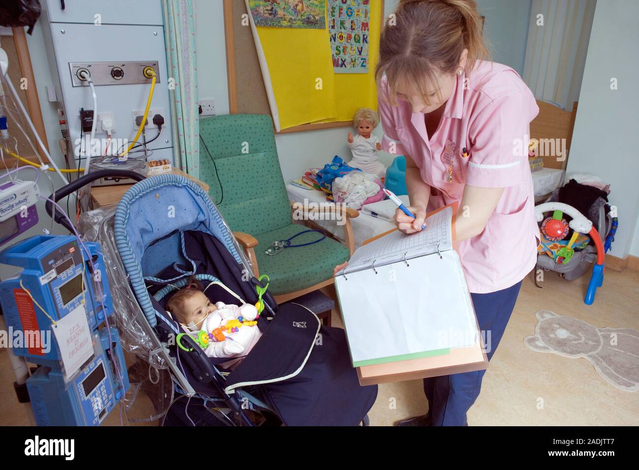 MODEL RELEASED. Unwell baby girl, with a staff nurse on the ward. This ...