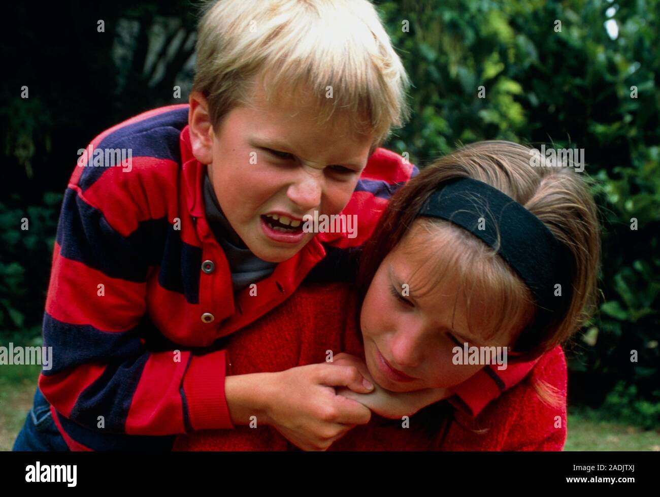 Fighting children. A girl and a boy having a play-fight Stock Photo - Alamy