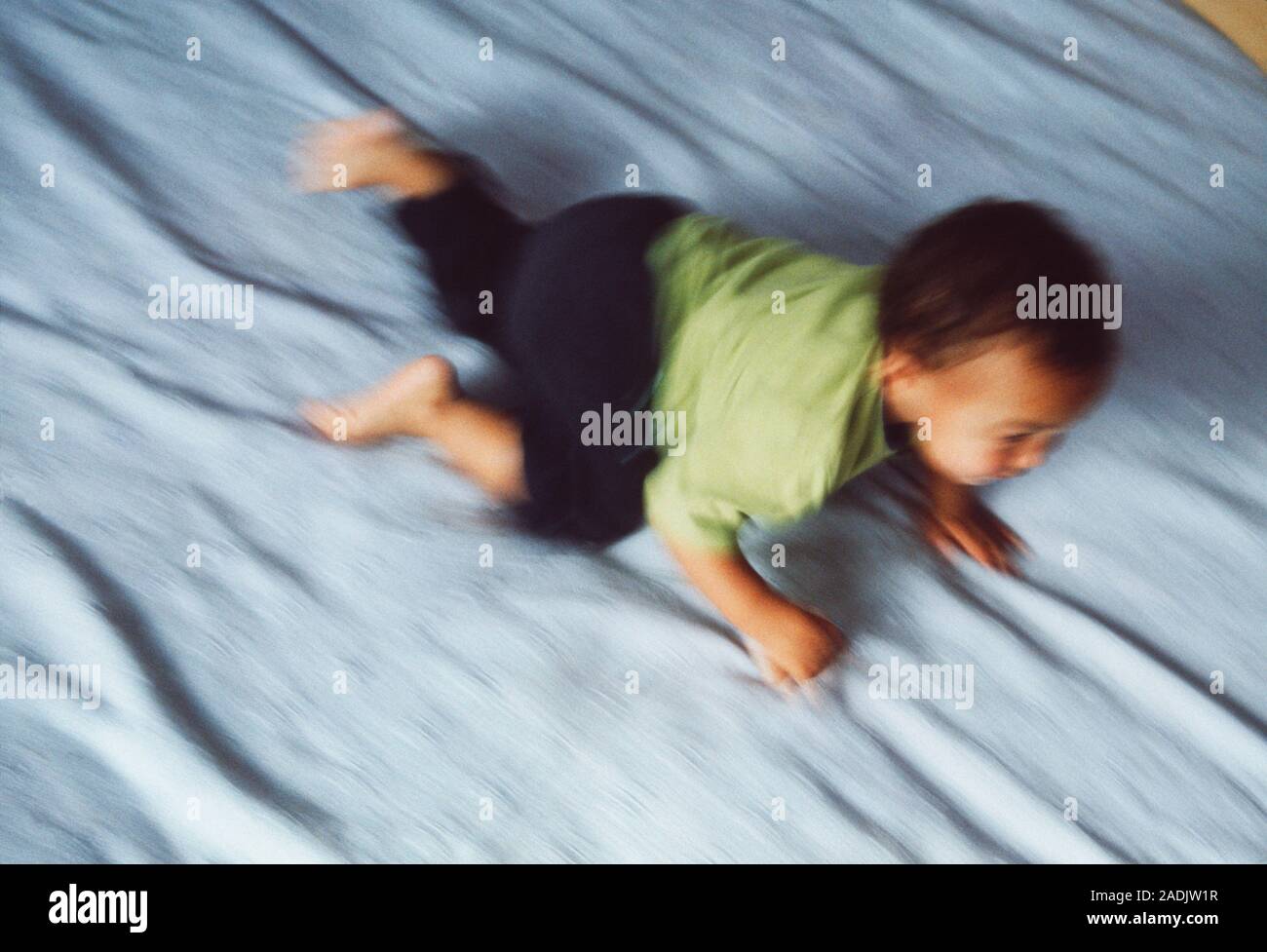 Baby boy. Time exposure image of a 16-month-old baby boy crawling Stock ...