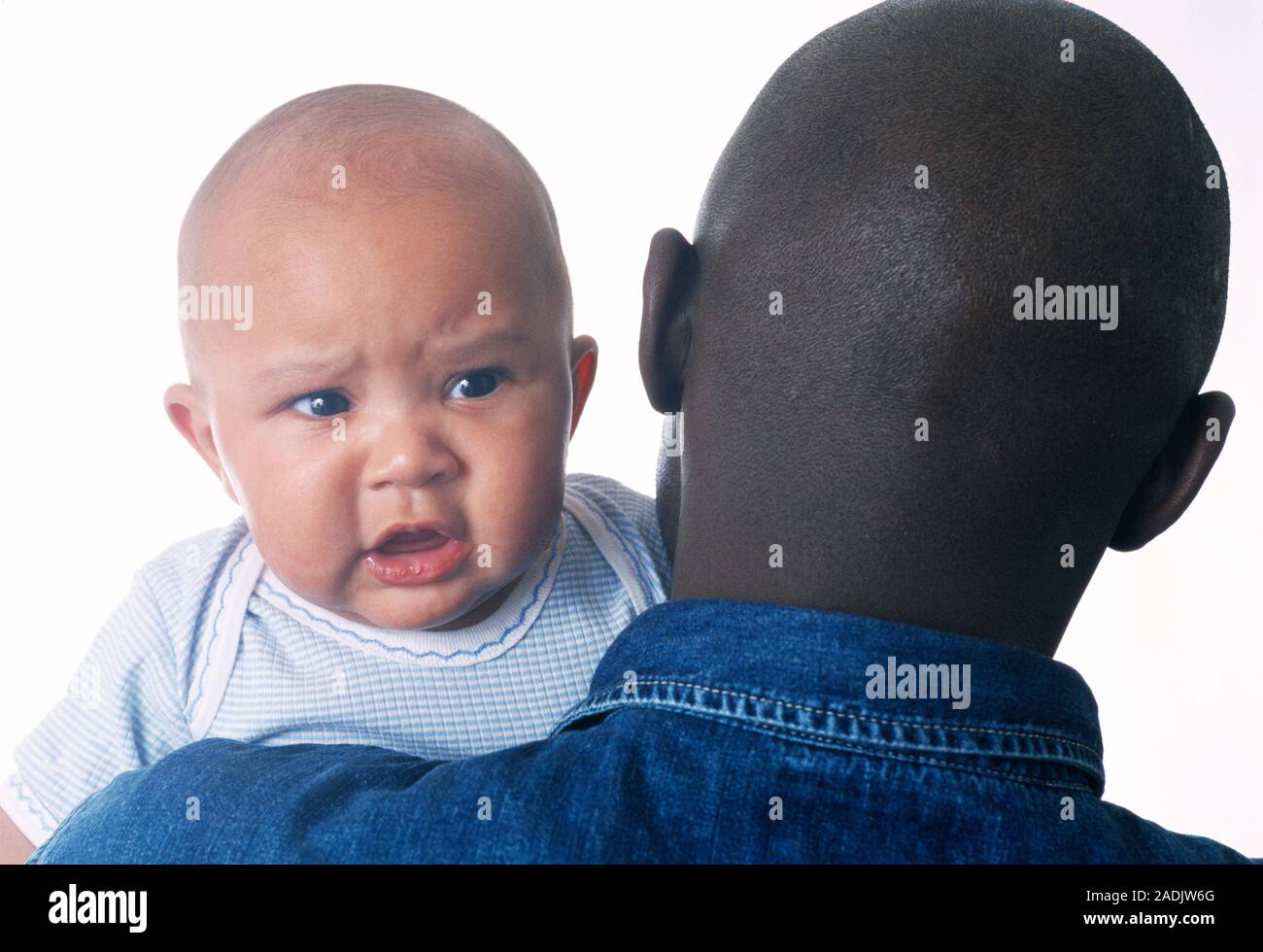 Father holding baby. Father holding his concerned-looking four-month ...