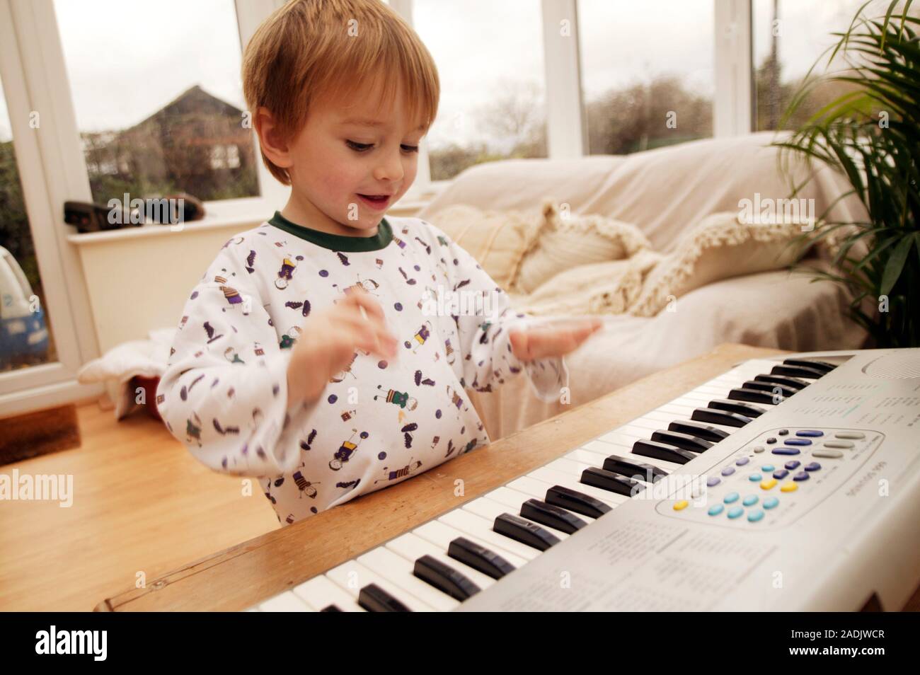 Electronic keyboard being played by young boy Stock Photo - Alamy