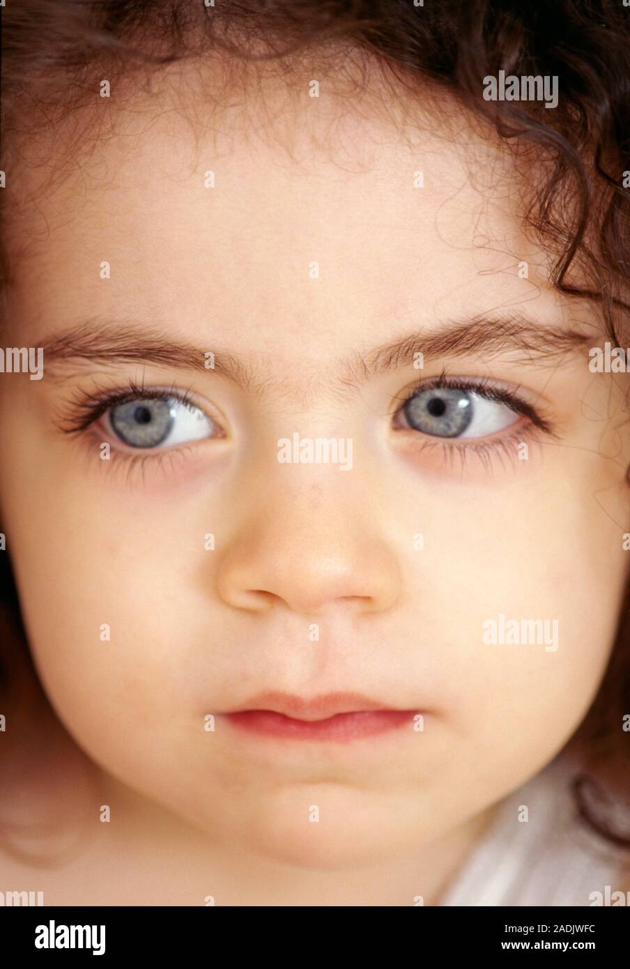 Child's face. Young girl staring into the distance. She has a ...