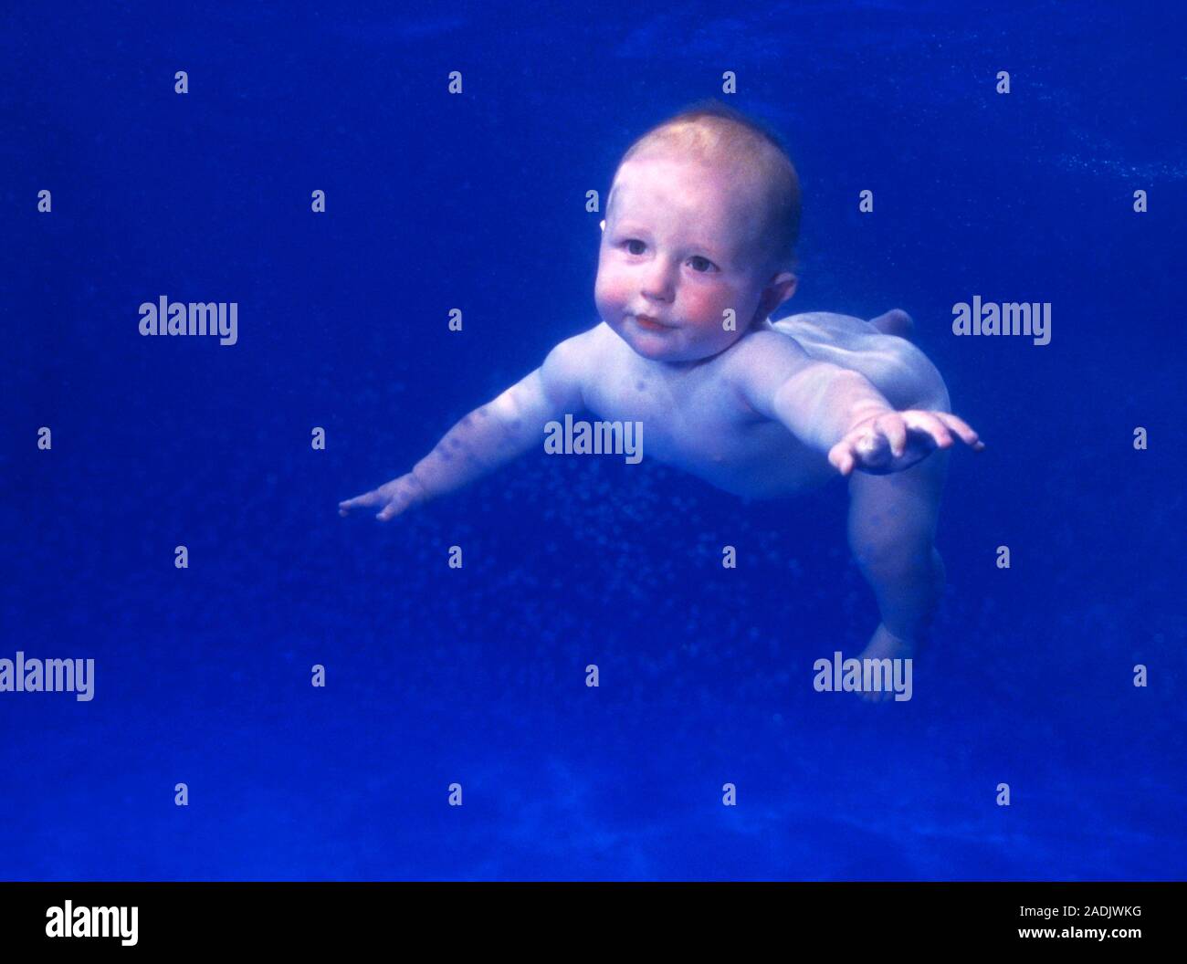 Baby swimming underwater Stock Photo - Alamy