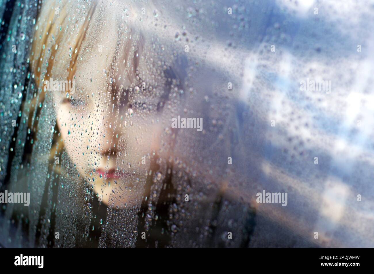 Sad child in the back of a car Stock Photo - Alamy