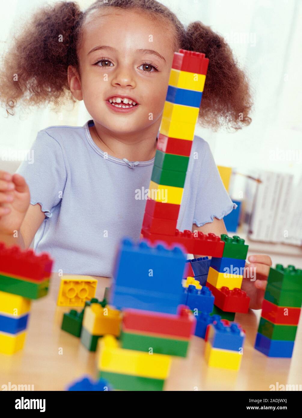 MODEL RELEASED. Girl playing with lego. Three year old girl building ...