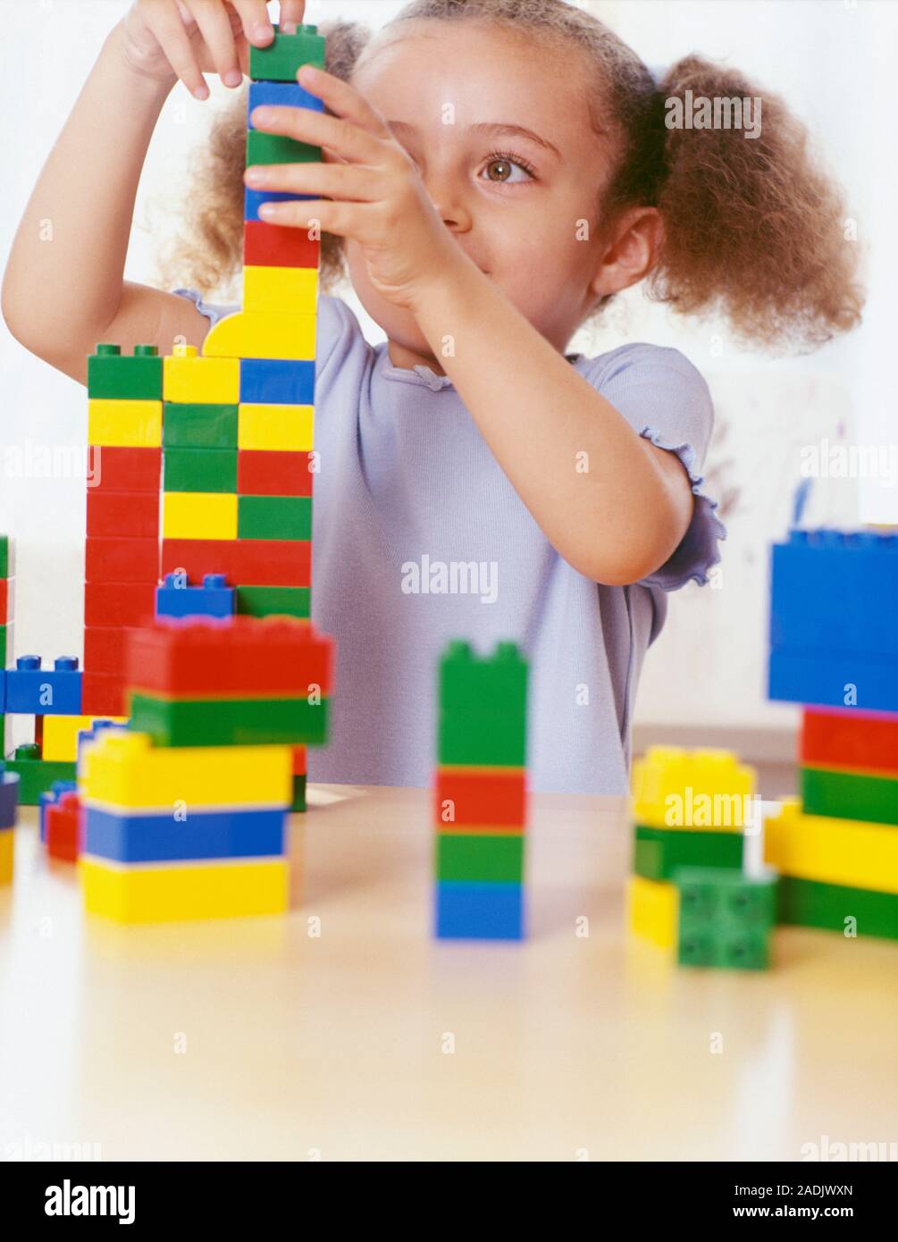MODEL RELEASED. Girl playing with lego. Three year old girl building ...