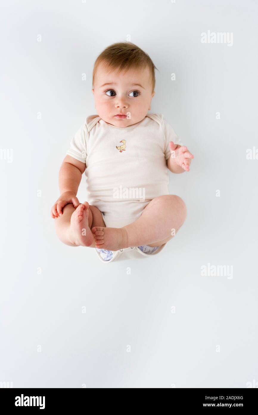 MODEL RELEASED. Baby boy on his back Stock Photo - Alamy