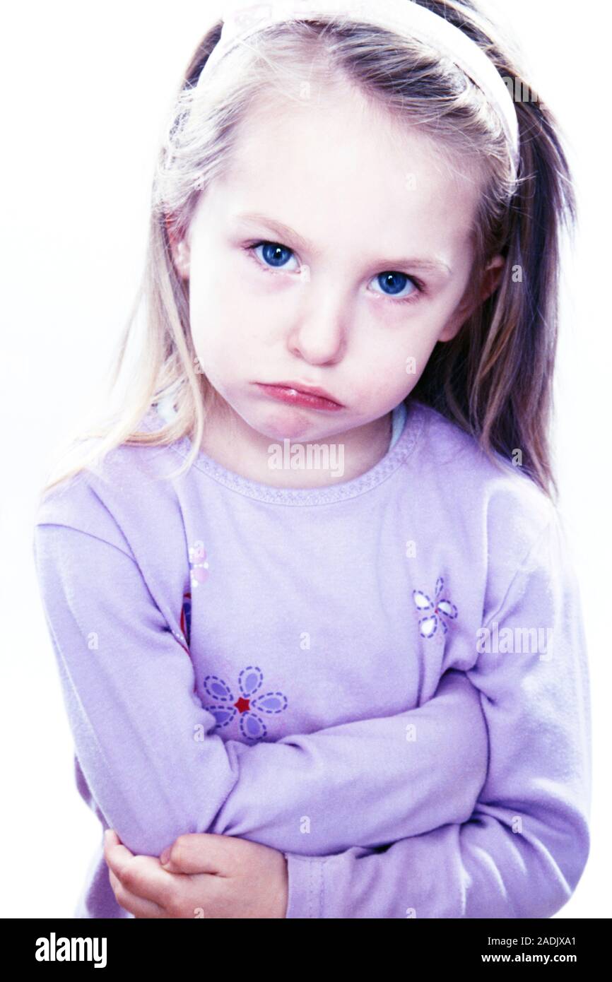 MODEL RELEASED. Grumpy girl with folded arms Stock Photo - Alamy