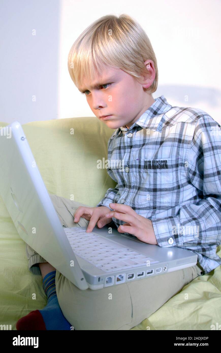 Laptop use. Boy using a laptop computer Stock Photo - Alamy