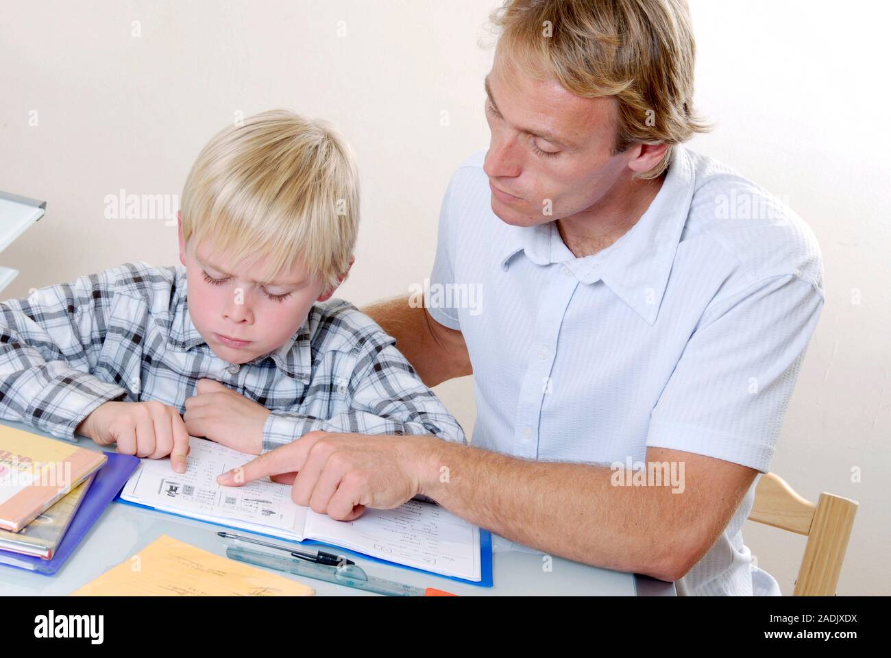 Homework. Father helping his son with his schoolwork Stock Photo - Alamy