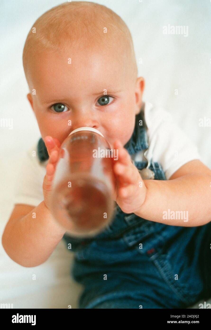 Baby drinking. Ten-month-old baby boy drinking from a bottle Stock ...