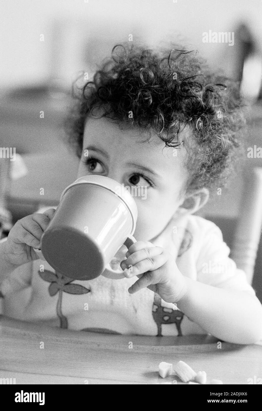 Baby girl drinking from a beaker. She is 14 months old. The beaker is ...
