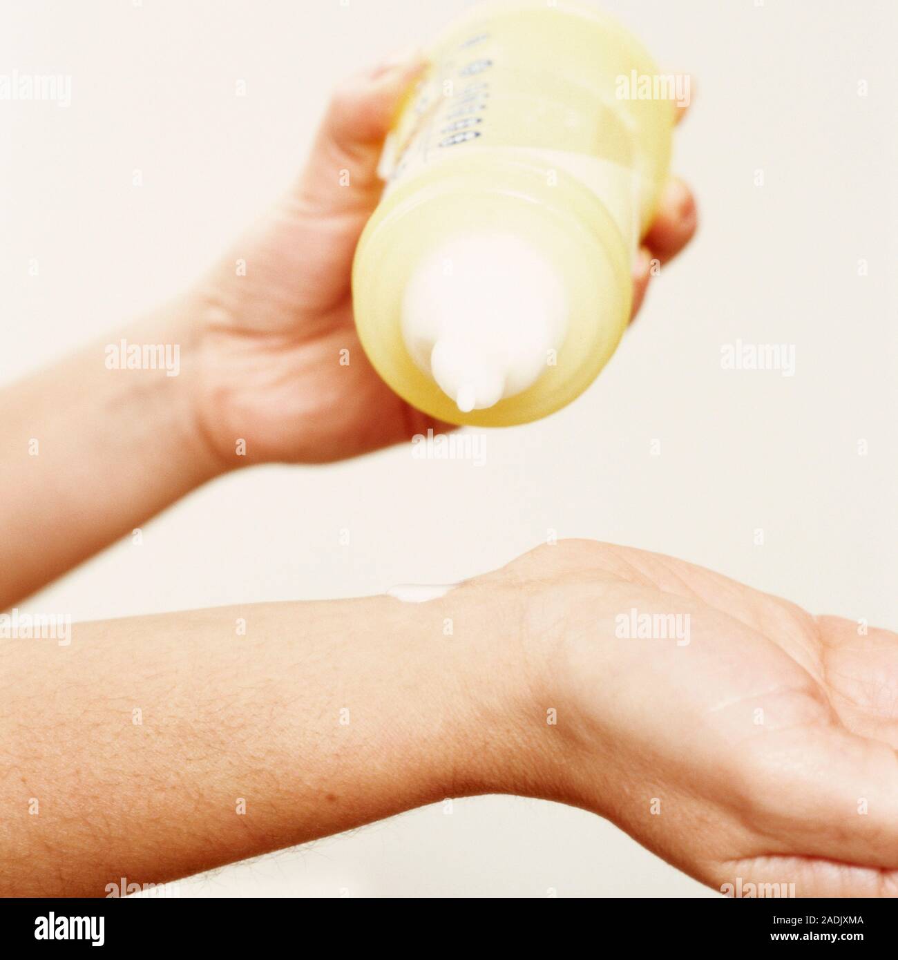 Baby milk. Woman testing the temperature of milk in a feeding bottle ...