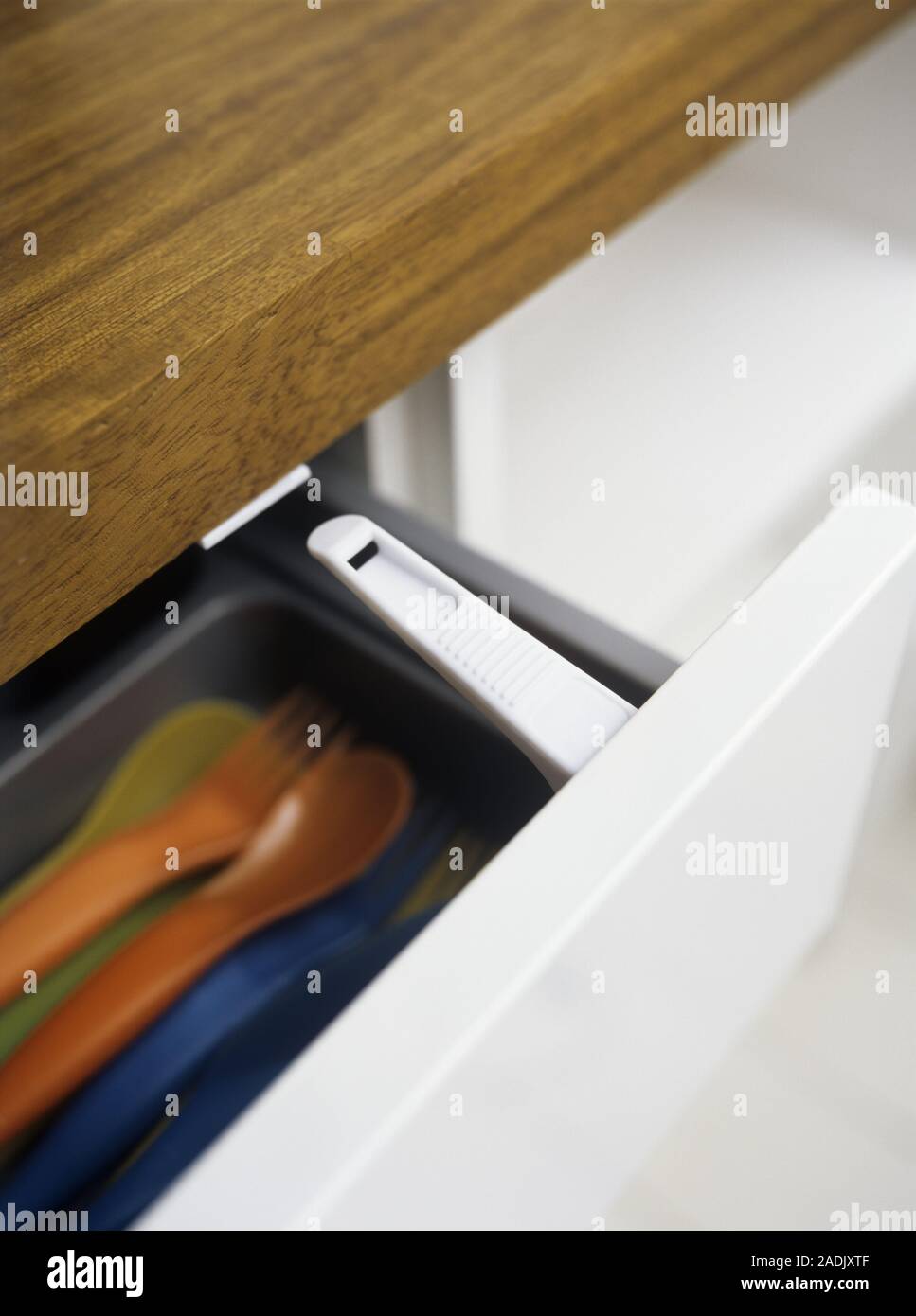 Child safety. Drawer catcher attached to the inside of a kitchen door ...