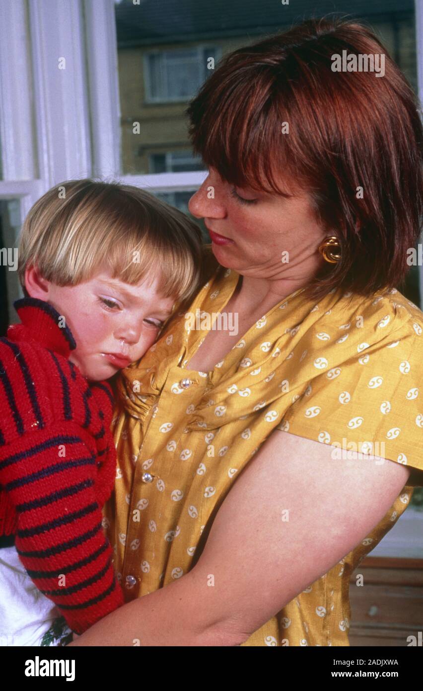 Model released. Mother comforting her sick, feverish child. Fever, also ...