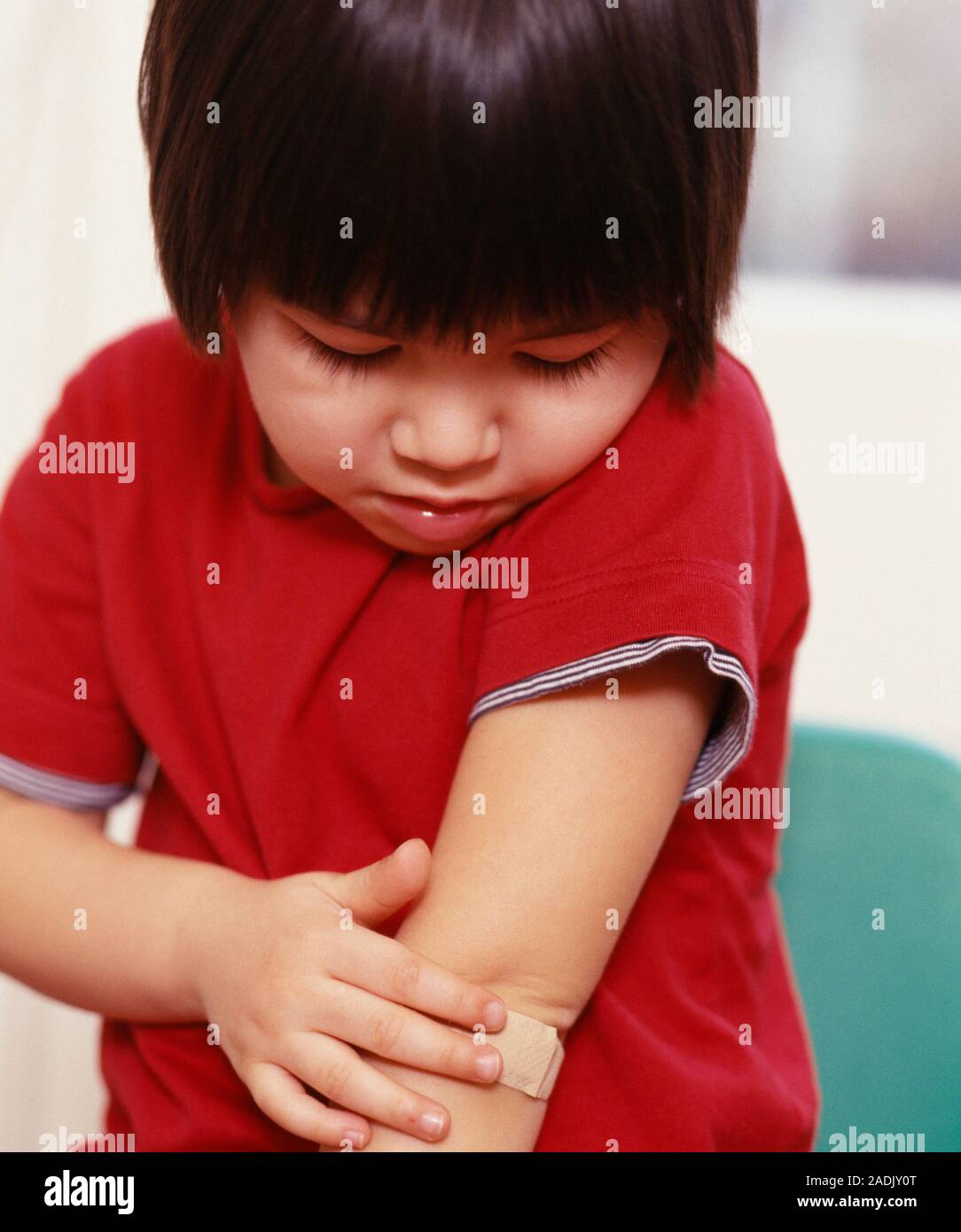 Elbow wound. 3-year-old boy with a plaster on an elbow wound. The ...