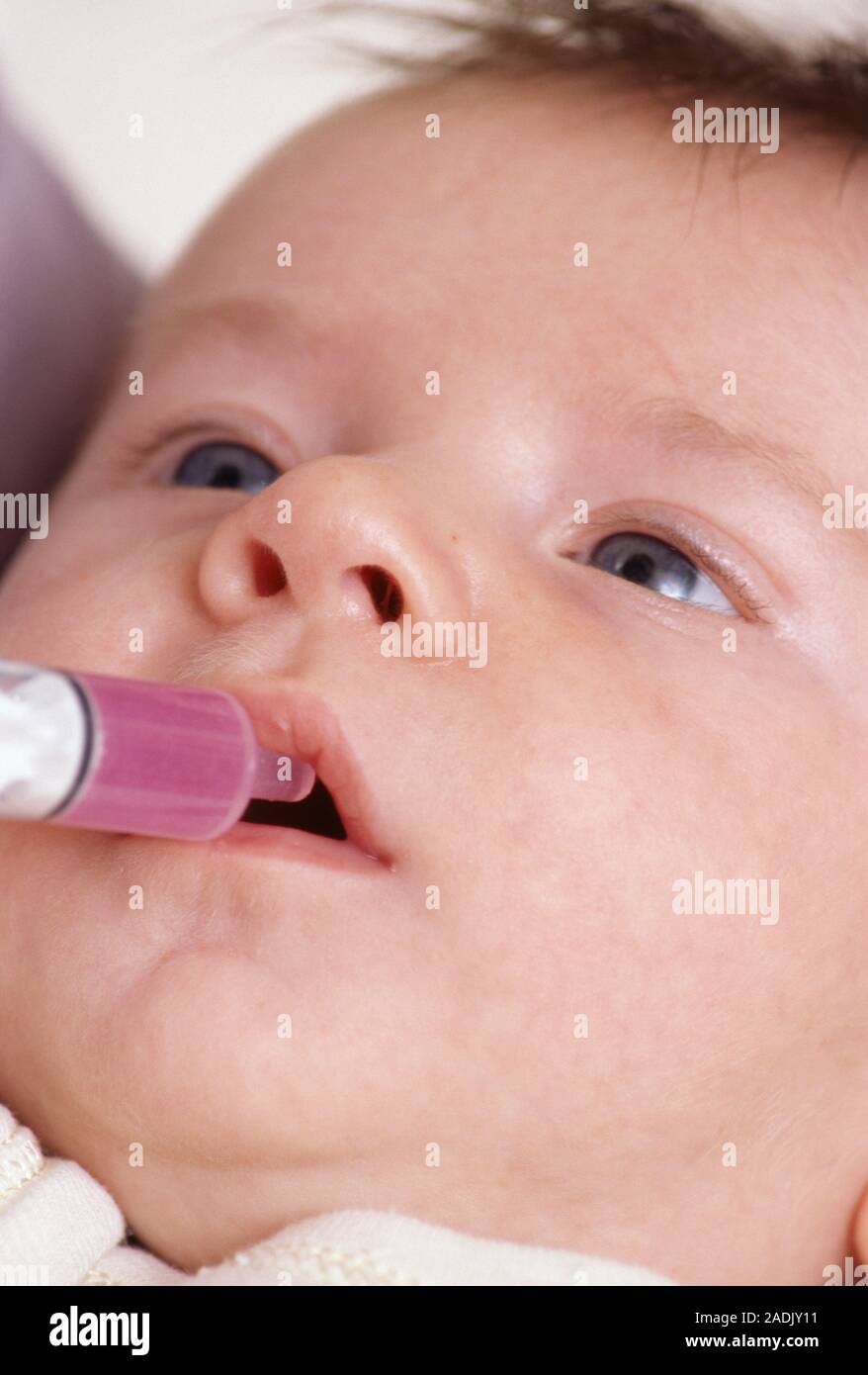 Baby's medicine. Syringe (without a needle) being used to deliver a ...