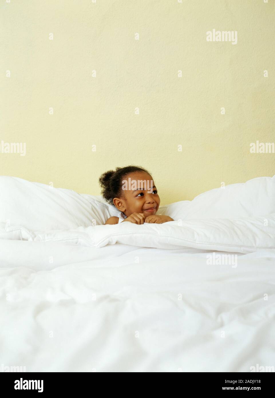 Feverish child. Four-year-old girl recovering from a fever in bed ...