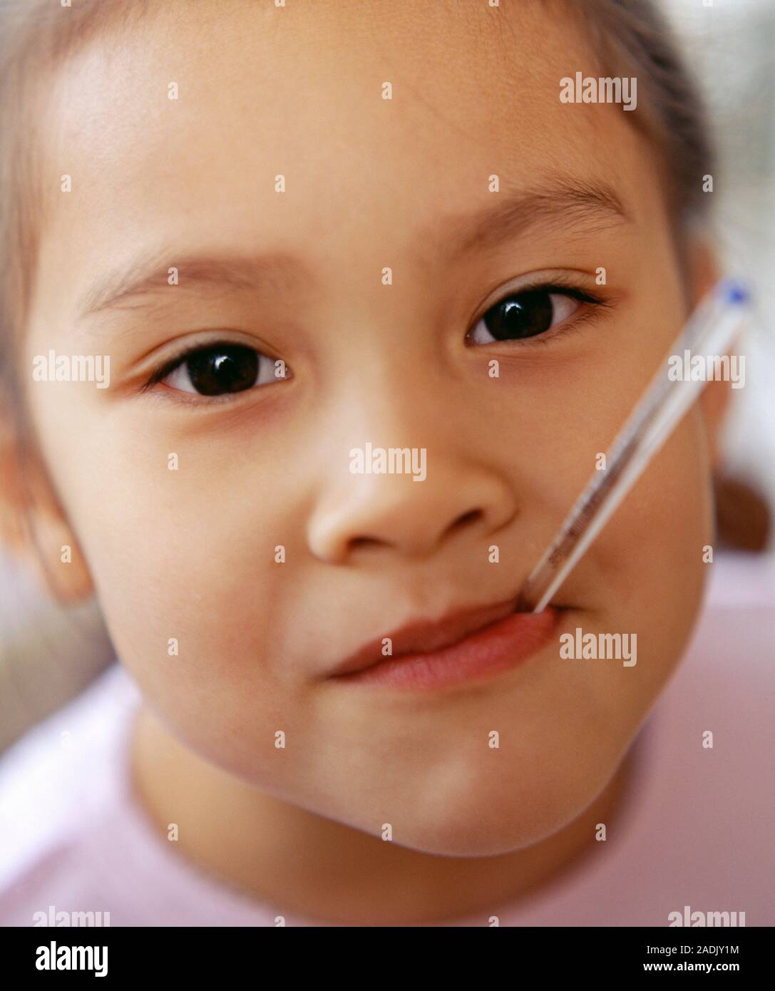 Feverish child. Five-year-old girl with a fever having her temperature ...