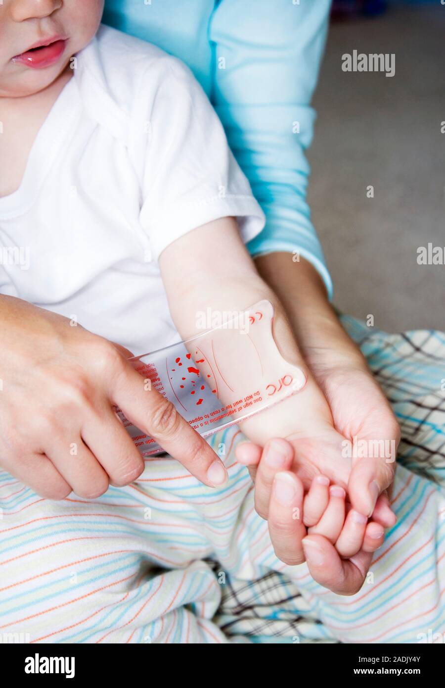 MODEL RELEASED. Meningitis and septicaemia test. Mother using the Arc ...