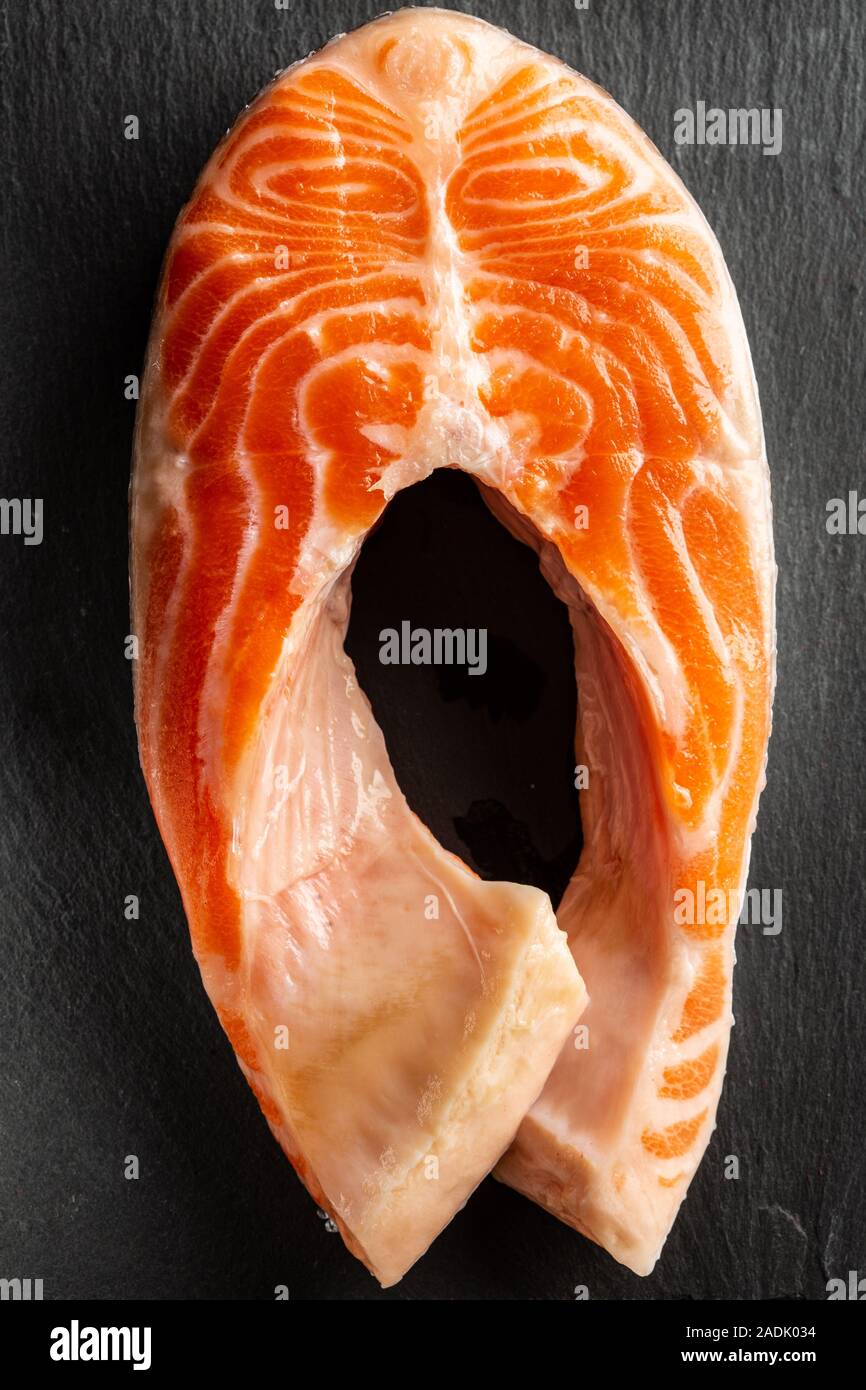 Raw red fish fillet on the black slate surface Stock Photo - Alamy