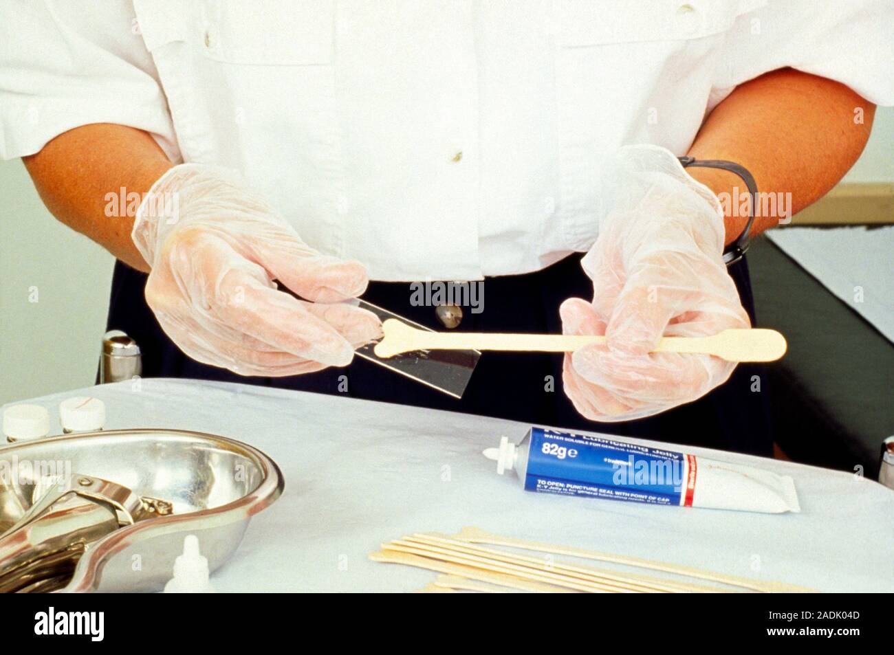 Nurse performing a cervical smear test. The nurse is seen here ...