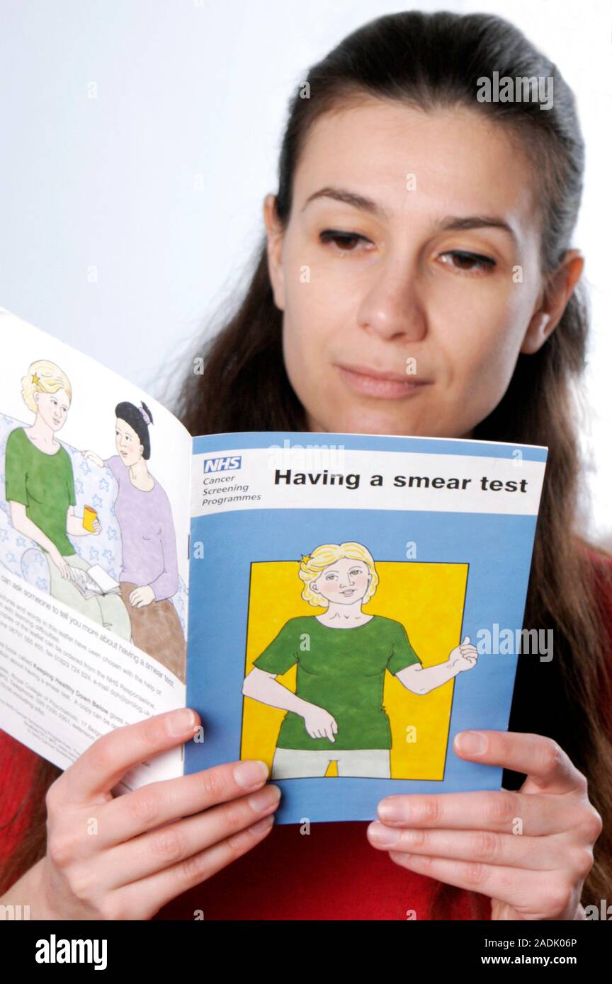 Smear test information. Woman reading guide on smear testing Stock ...