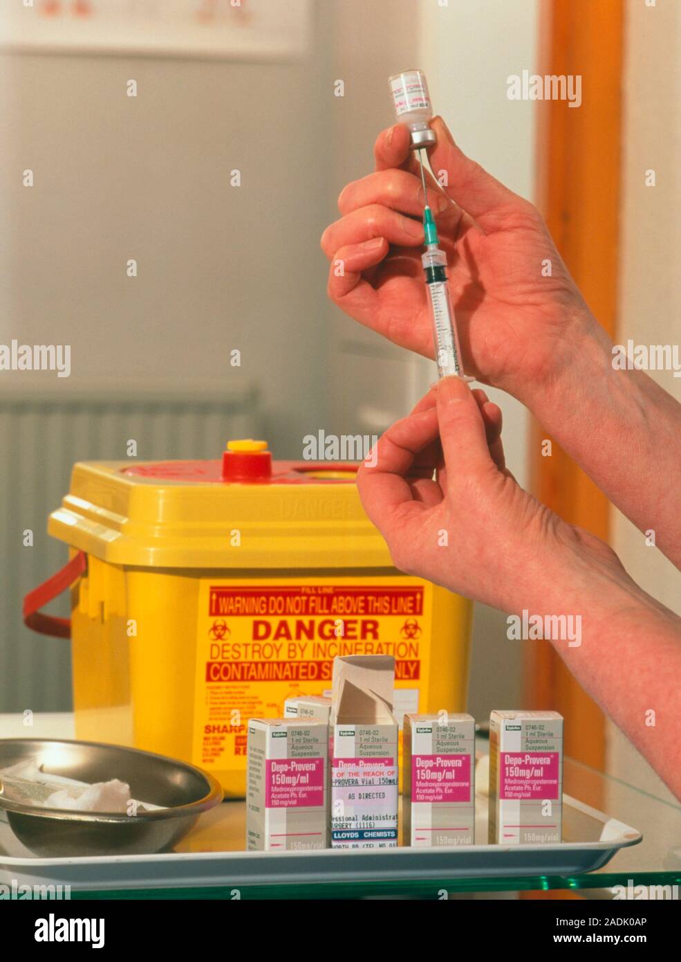 Depo-Provera. Nurse's hands prepare an injection of the female ...