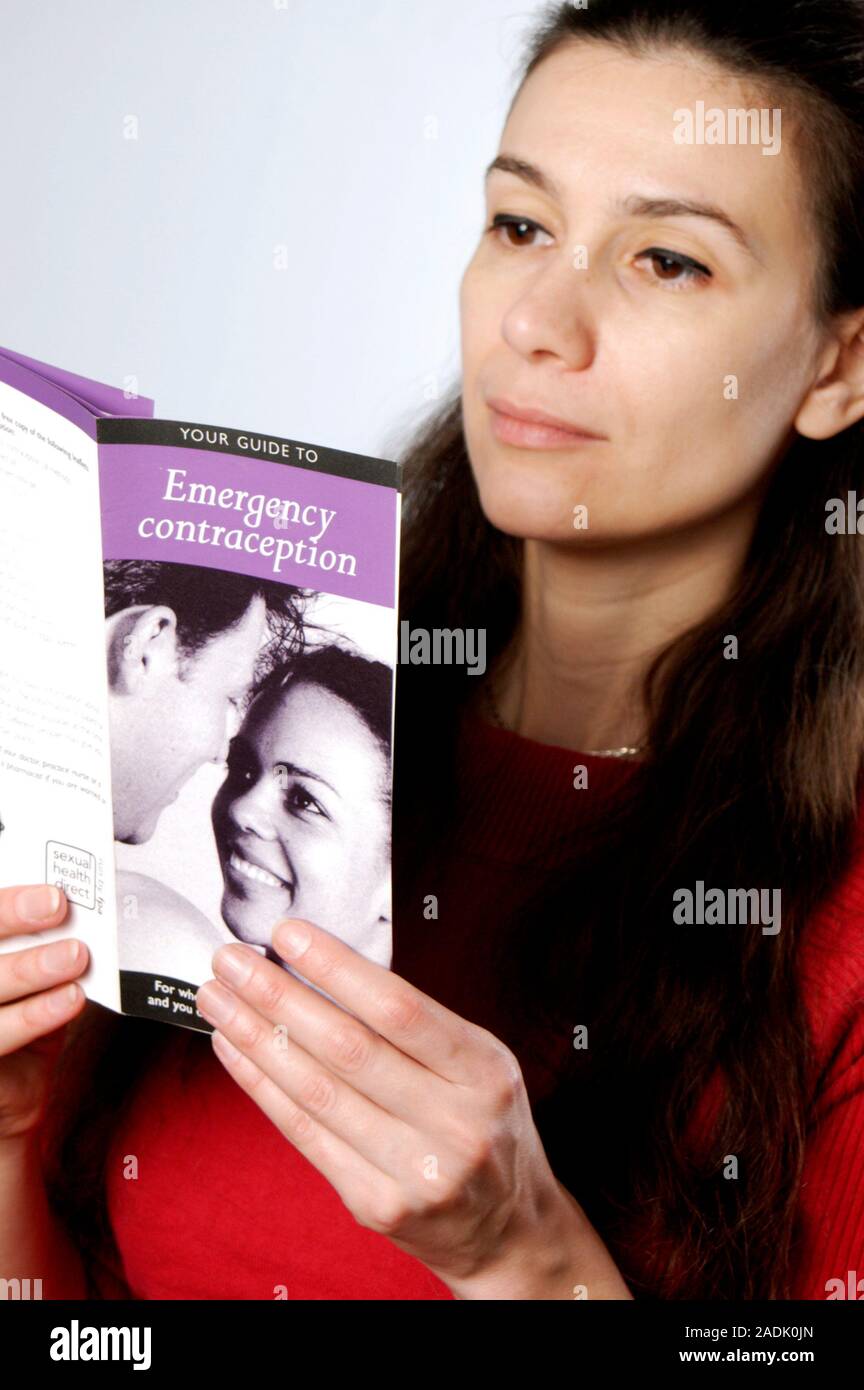 MODEL RELEASED. Contraception information. Woman reading leaflet on ...
