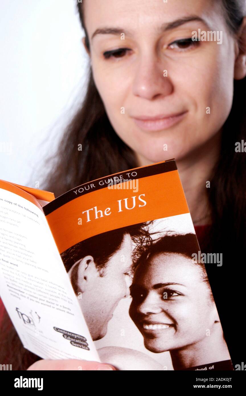 MODEL RELEASED. Contraception information. Woman reading leaflet on the ...