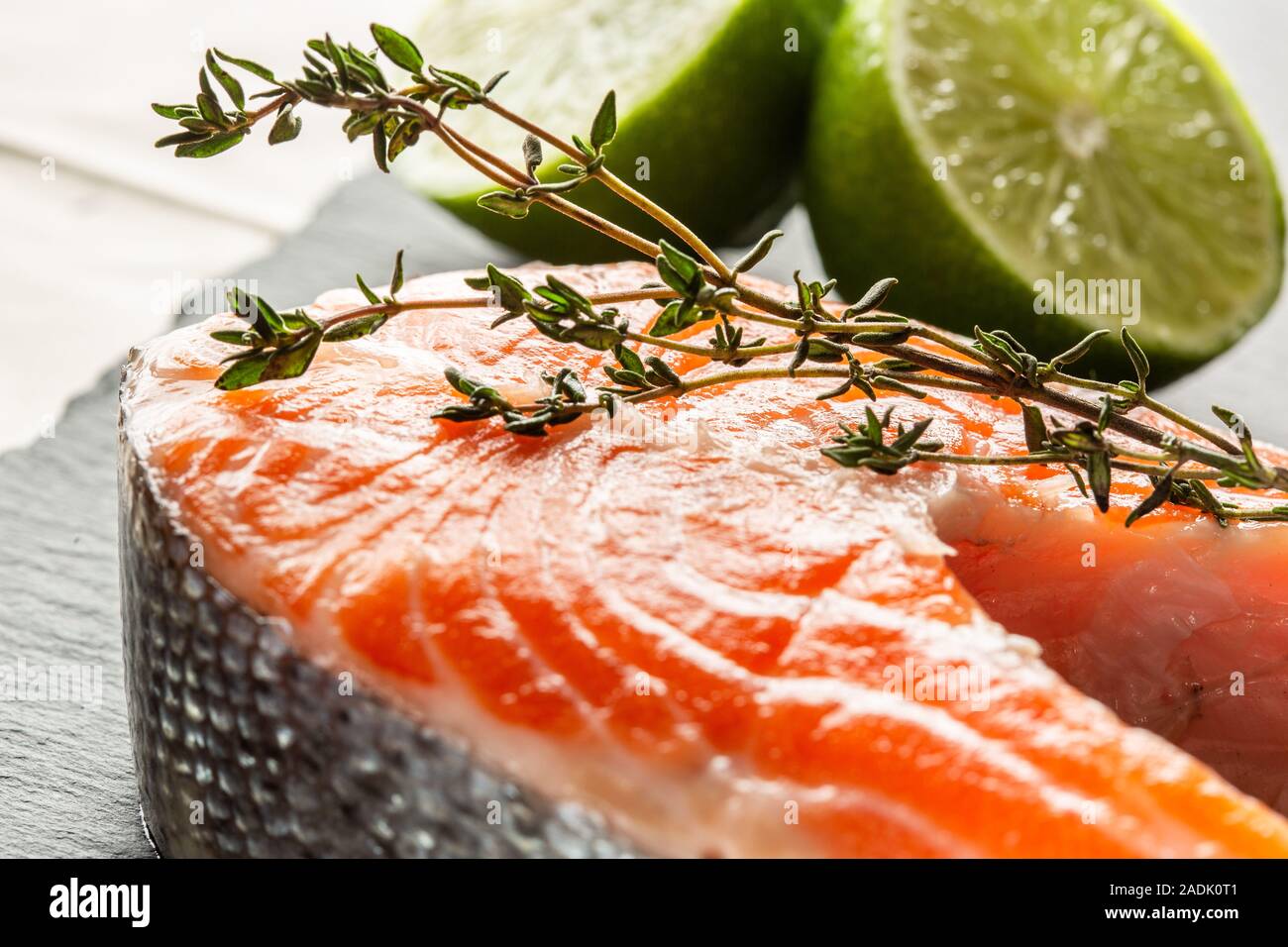 Branch of thyme lying on the smooth red fish surface Stock Photo - Alamy