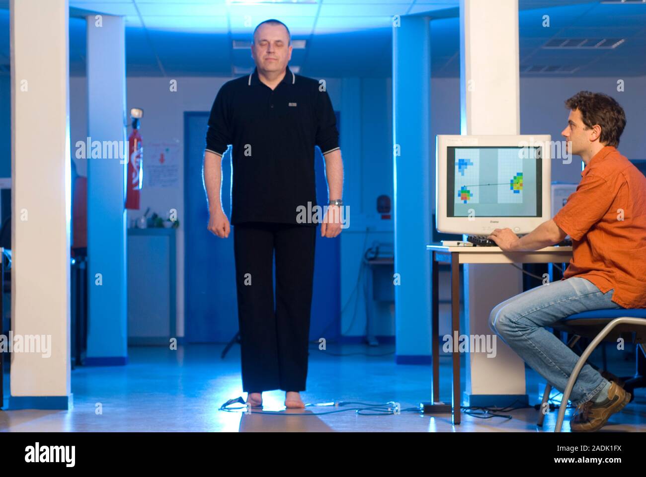 Amputee with Tongue Display Unit. Researcher (right) monitoring the use ...