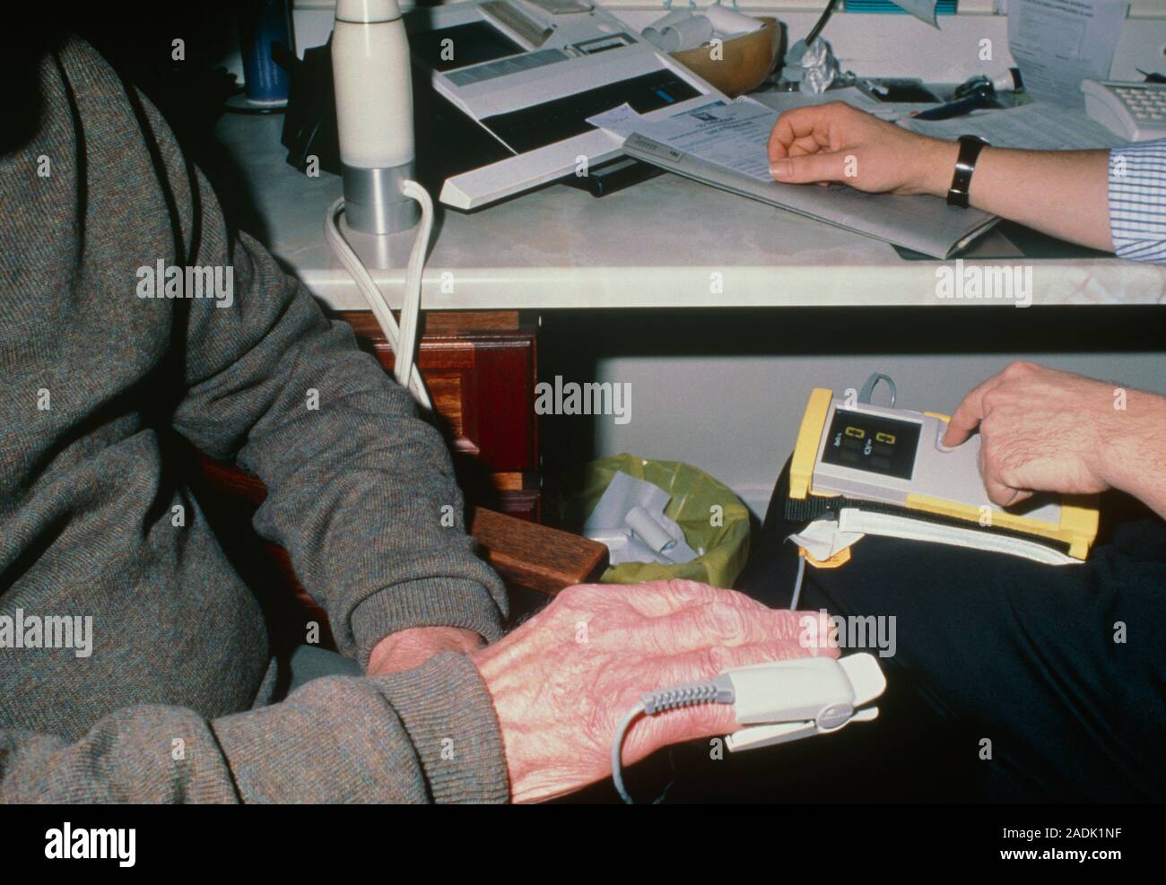 Pulse oximeter measurement. Elderly man's finger is attached to a ...