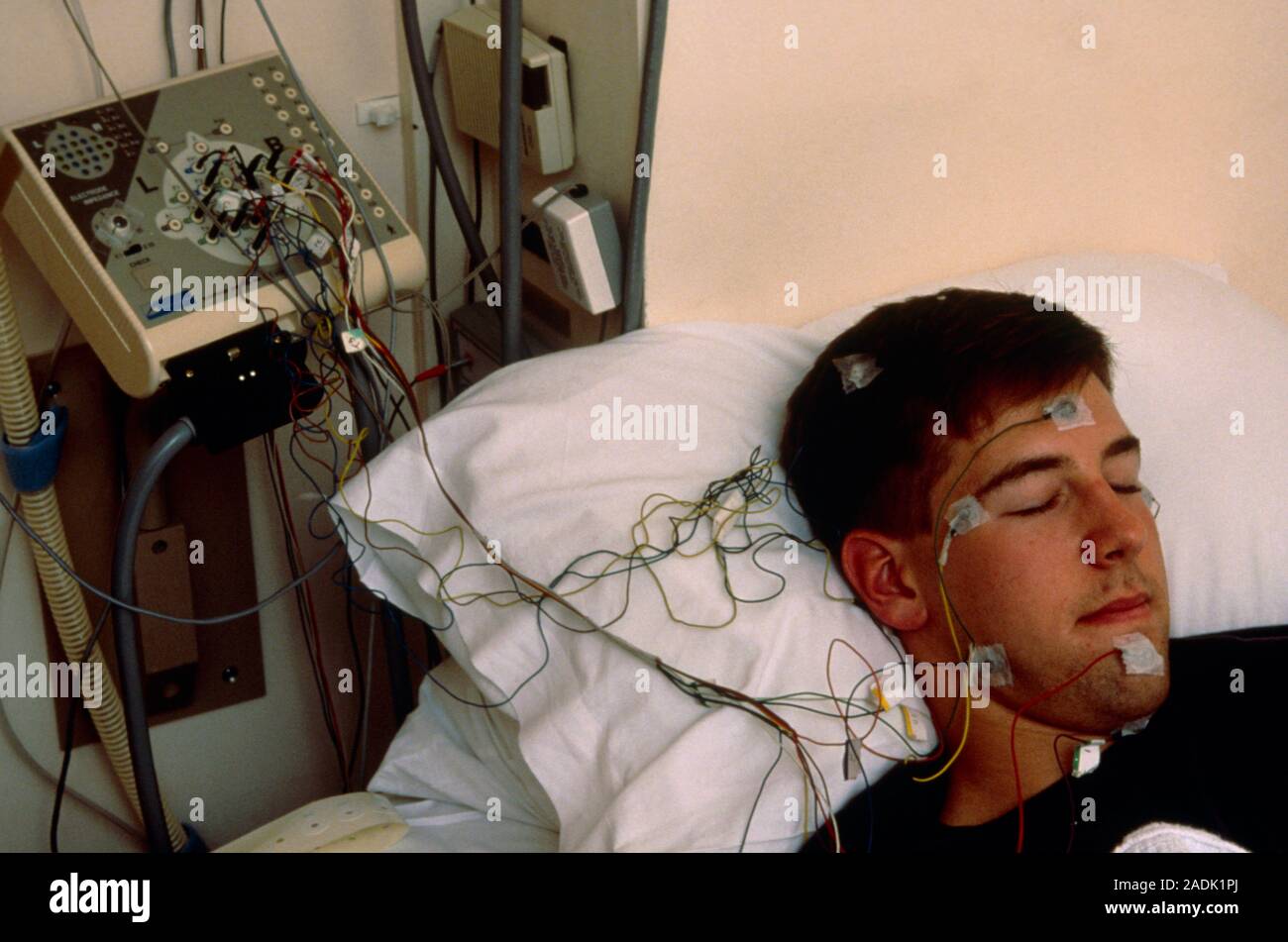 Circadian rhythm experiment. Male patient asleep in a sleep research ...