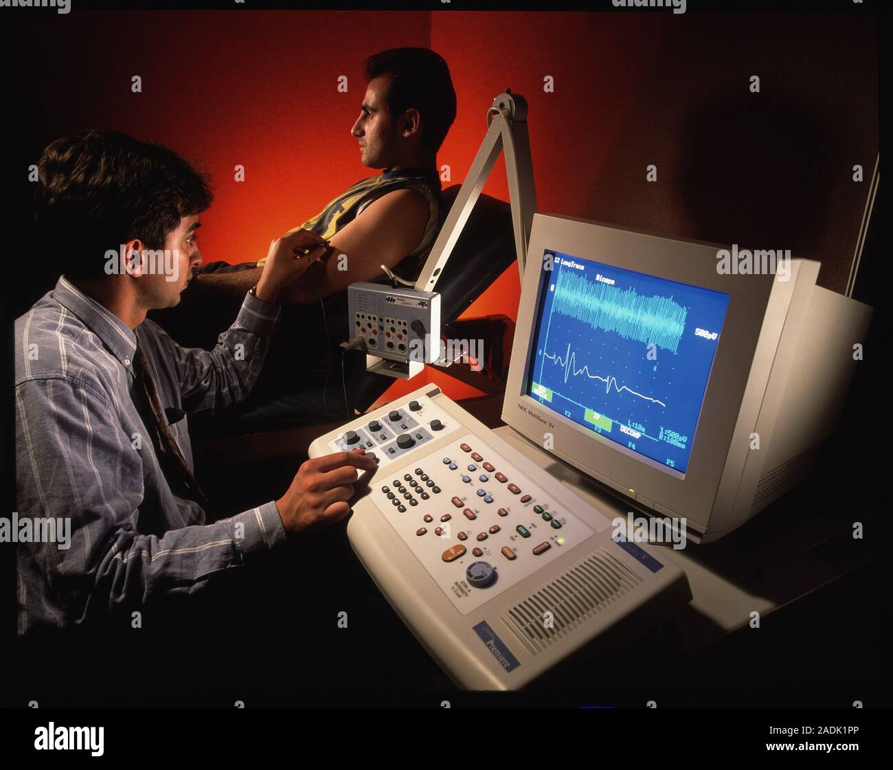Electromyography. Man undergoing an electromyography (EMG) test to ...
