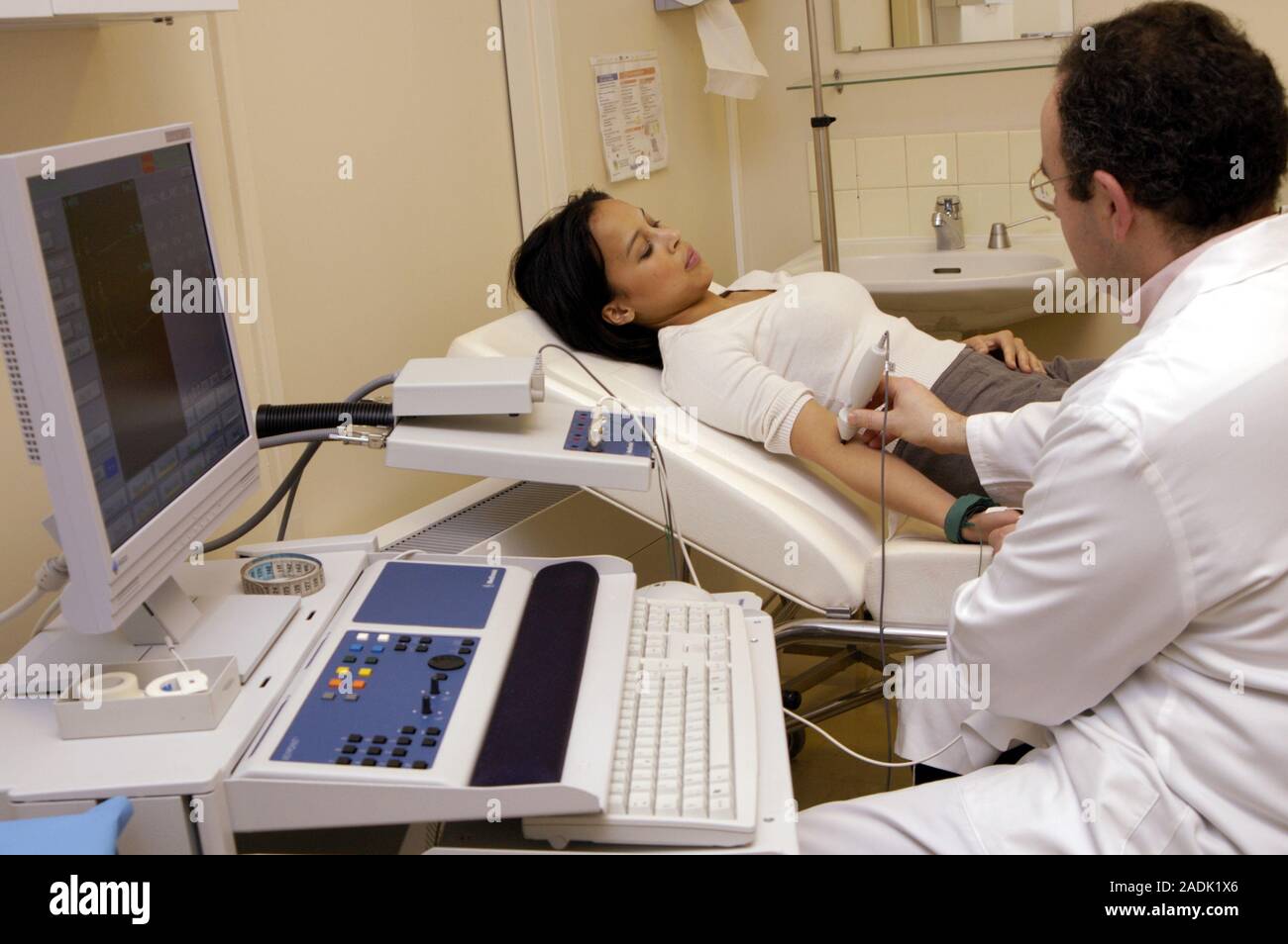 Nerve test. Woman undergoing a nerve conduction velocity test (NCV ...