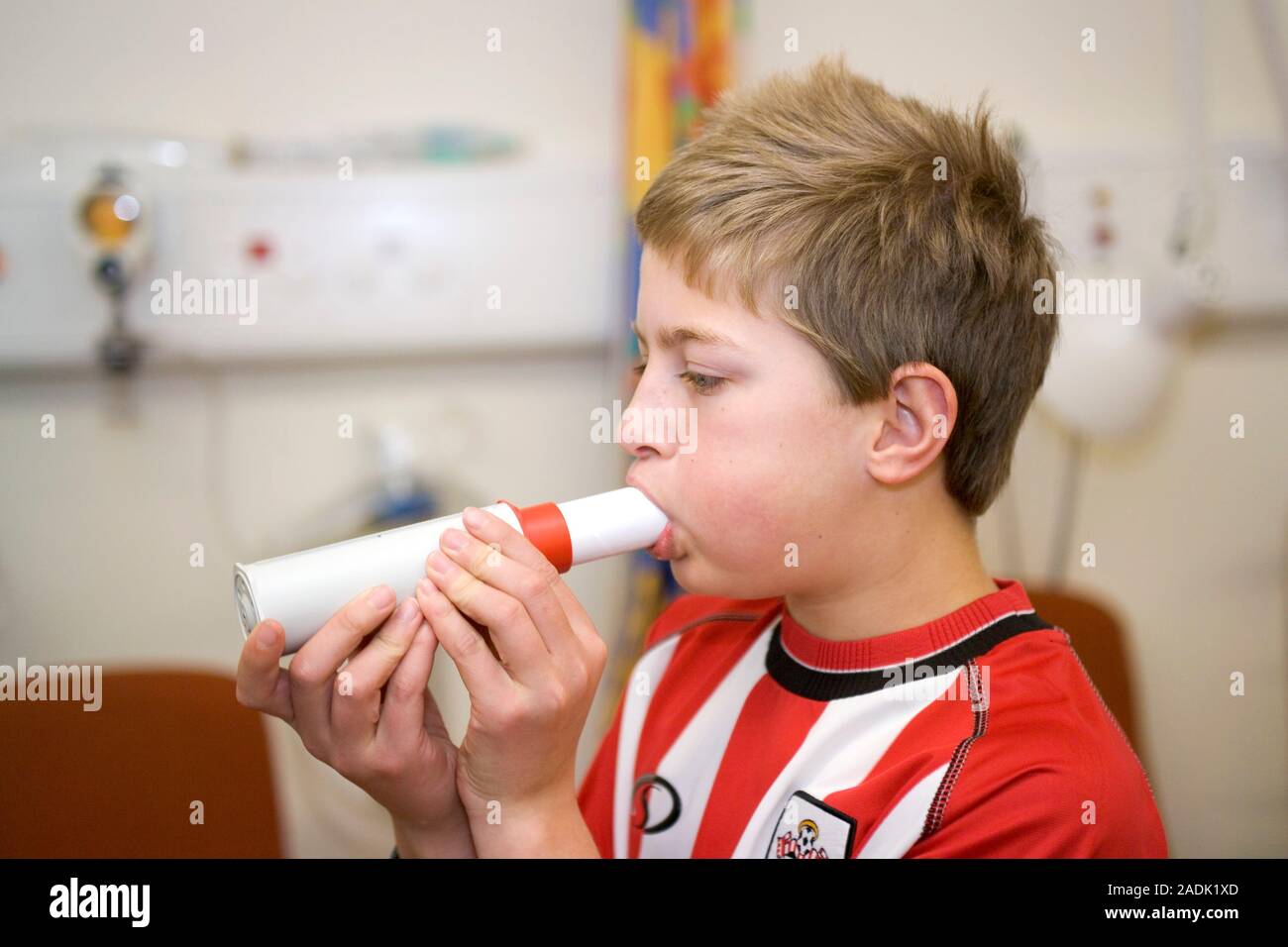 MODEL RELEASED. Lung function test. 10-year-old boy breathing into a ...