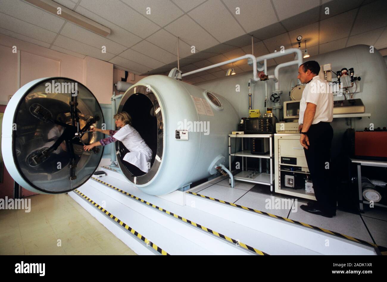 Physiological research. Researchers preparing a pressure chamber for ...