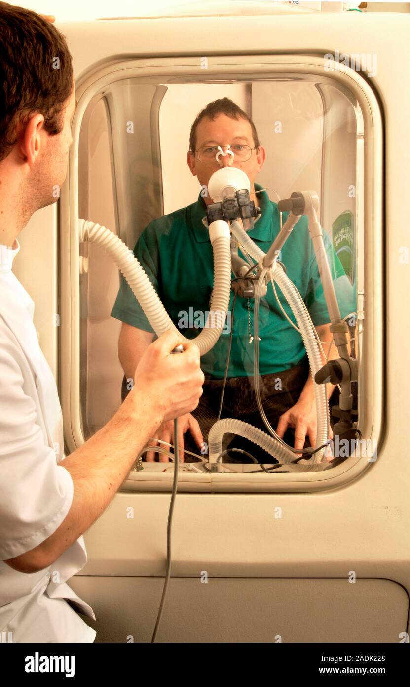 MODEL RELEASED. Lung function test. Doctor supervising a patient during ...