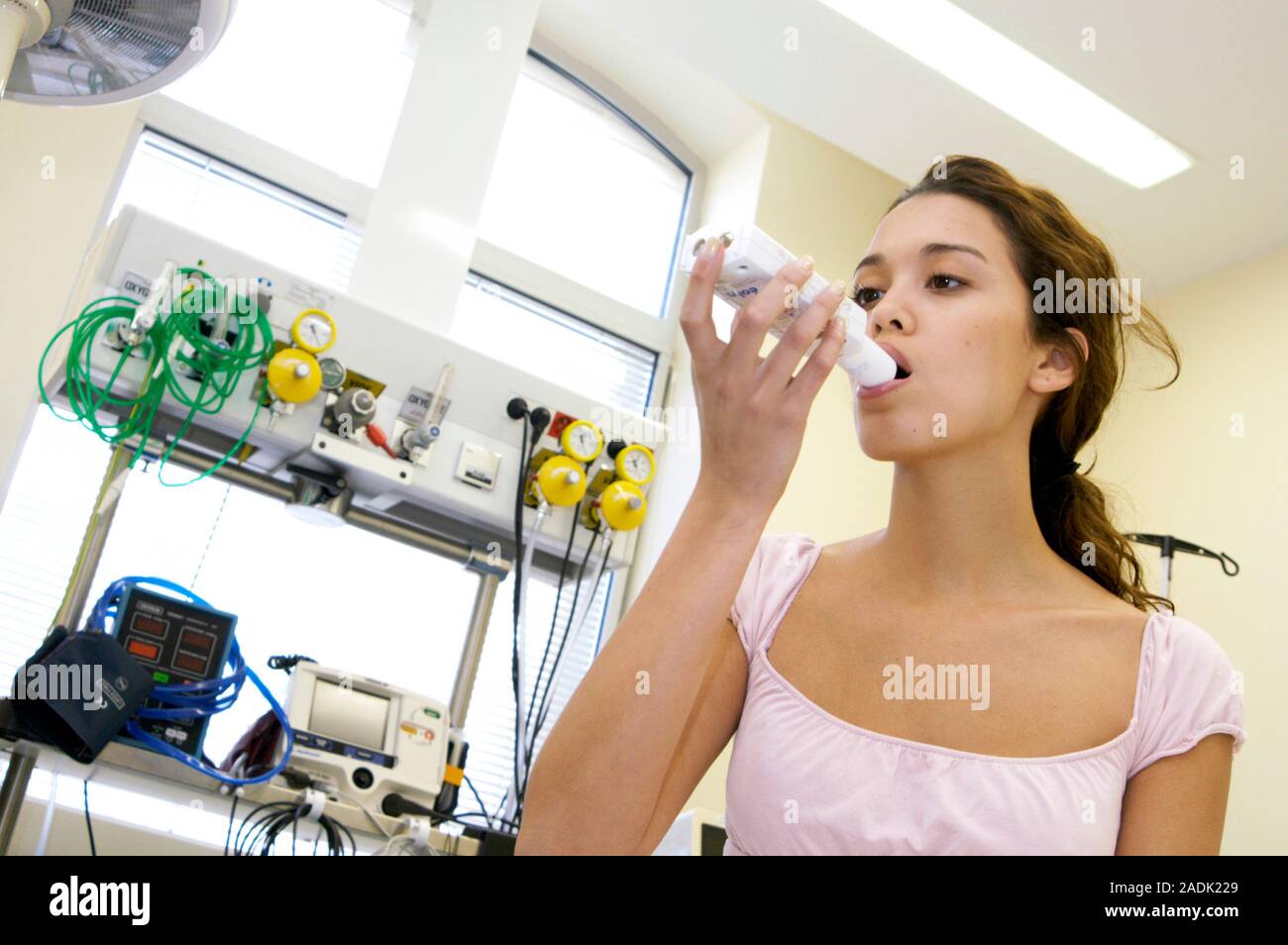 MODEL RELEASED. Lung function test. Young woman breathing into a peak ...