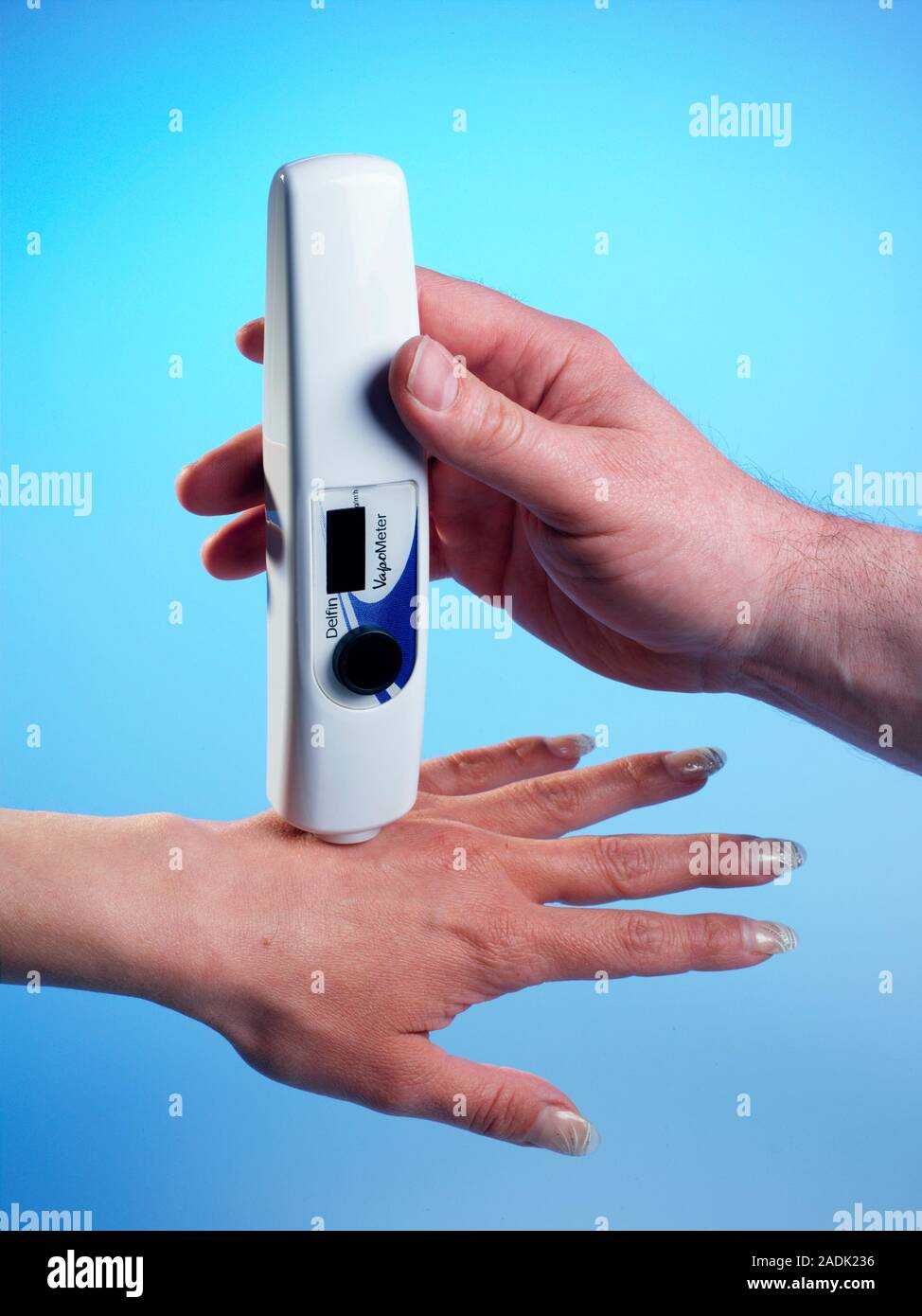 Measuring skin water loss. Dermatologist using an evaporimeter on a ...