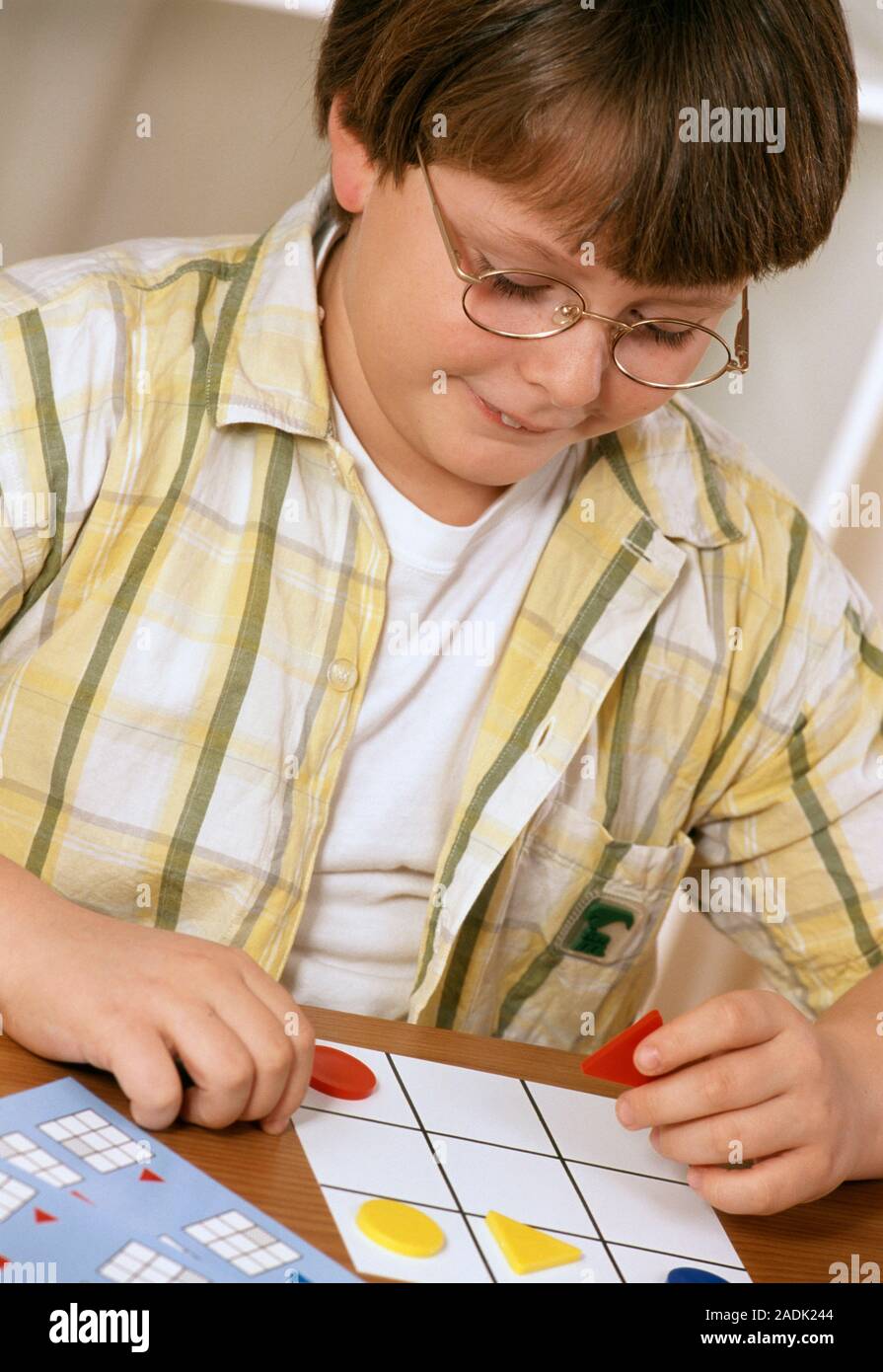 Childhood development test. Boy attempting a test as part of an ...