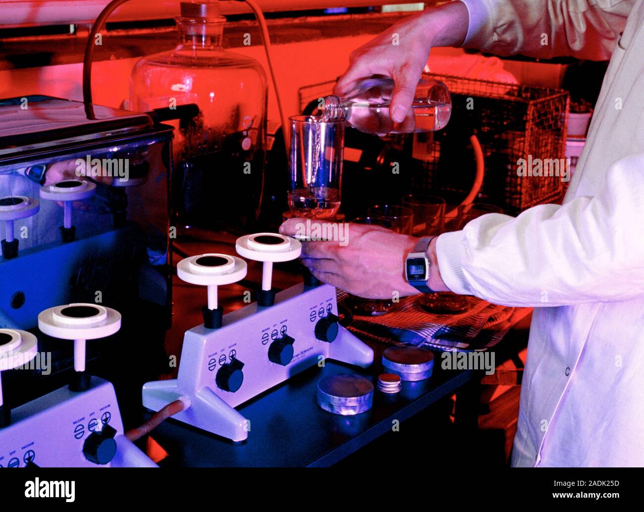 Microbiologist testing a water sample for bacterial contamination using ...