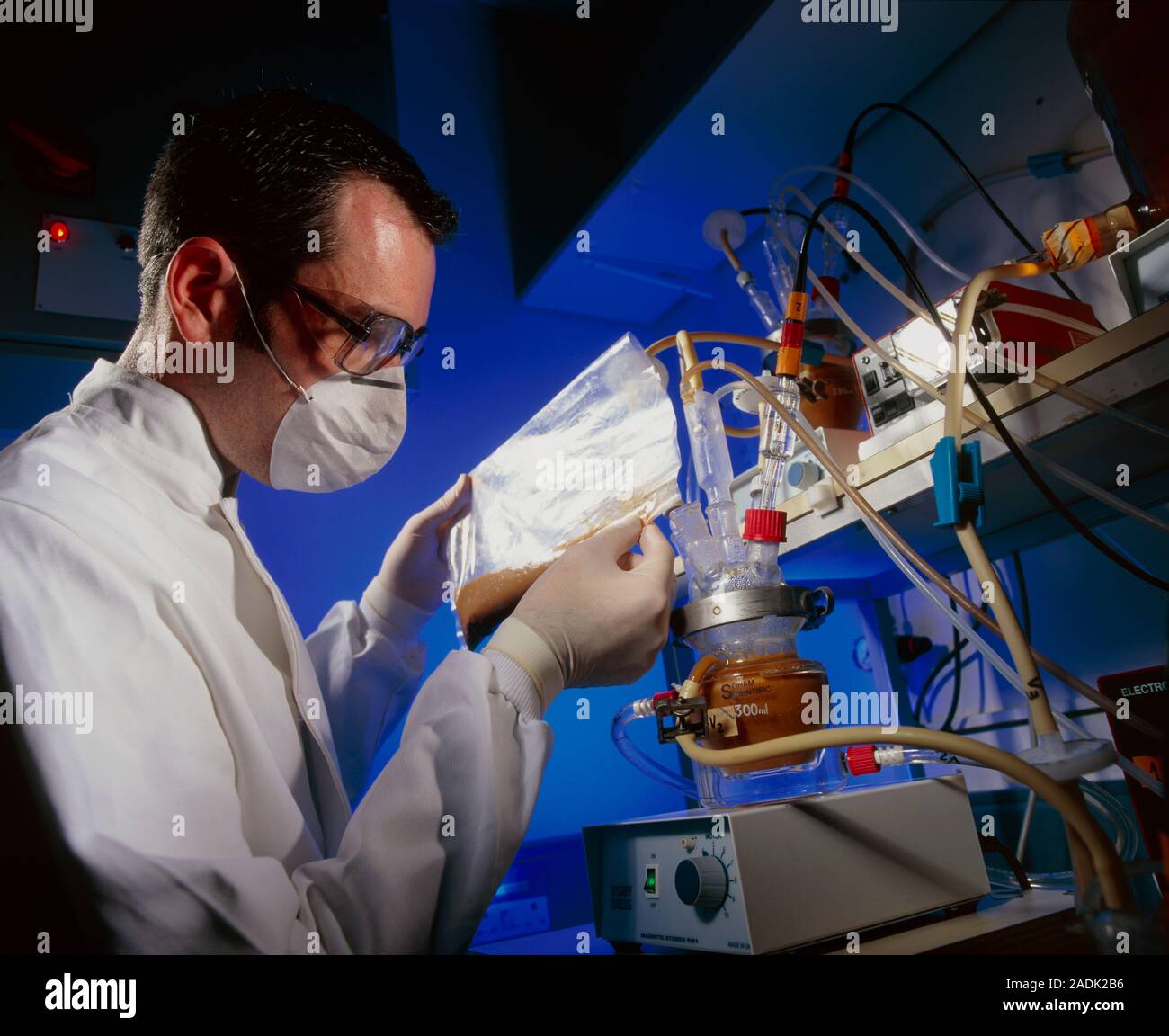 Artificial gut. Researcher inoculating an artificial gut used to model ...