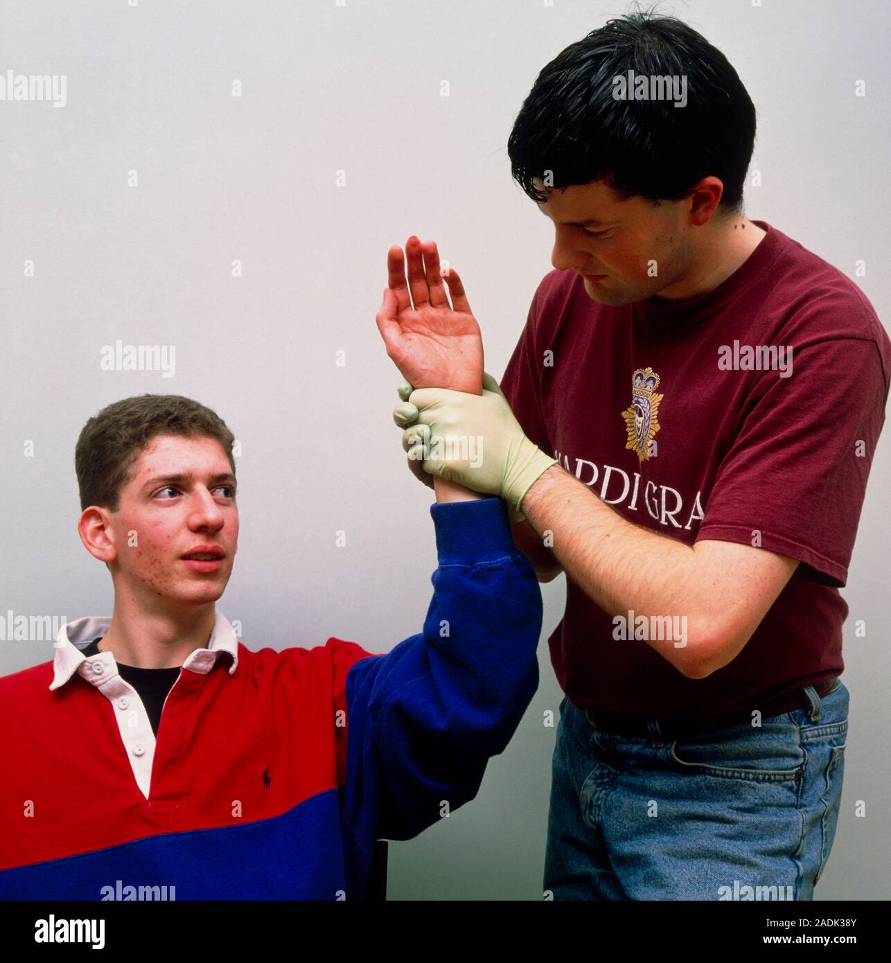 First aid for bleeding (image 1 of 3). Trainee first aider applies ...