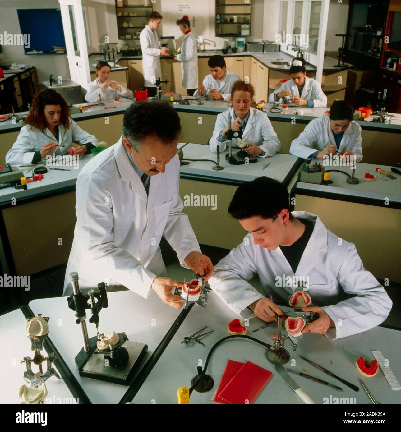 Dental training. Trainee dental technicians being taught how to make ...